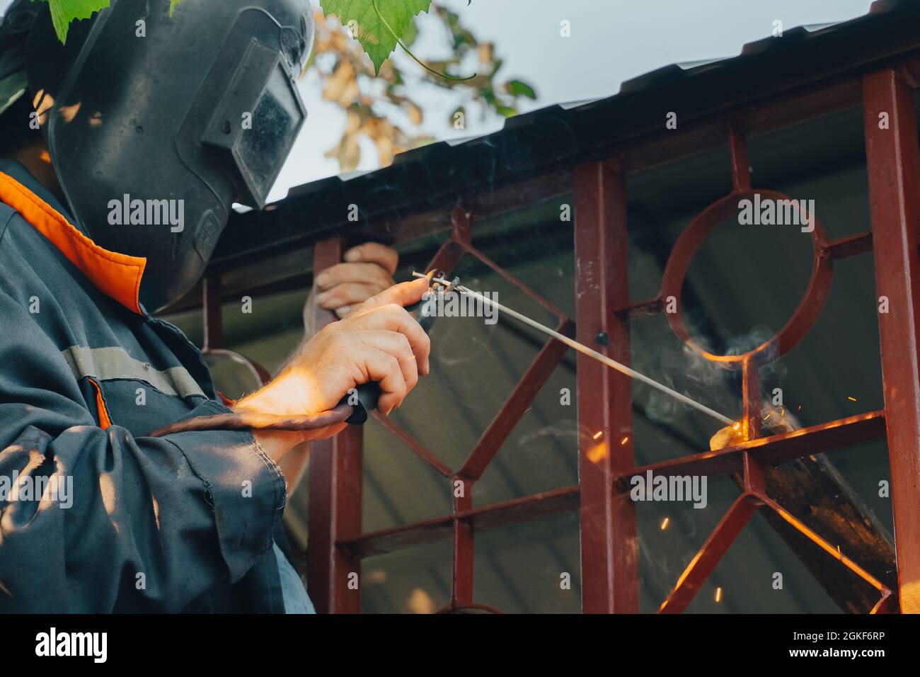 Close up of a welder hands welding steel structure metal part in home ...