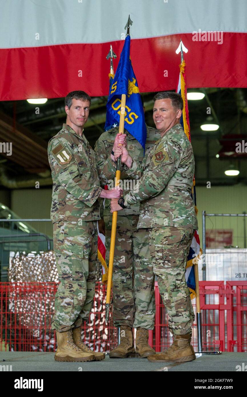 U.S. Air Force Col. Sean Lowe, 48th Operations Group commander, left, passes the unit guidon to ...
