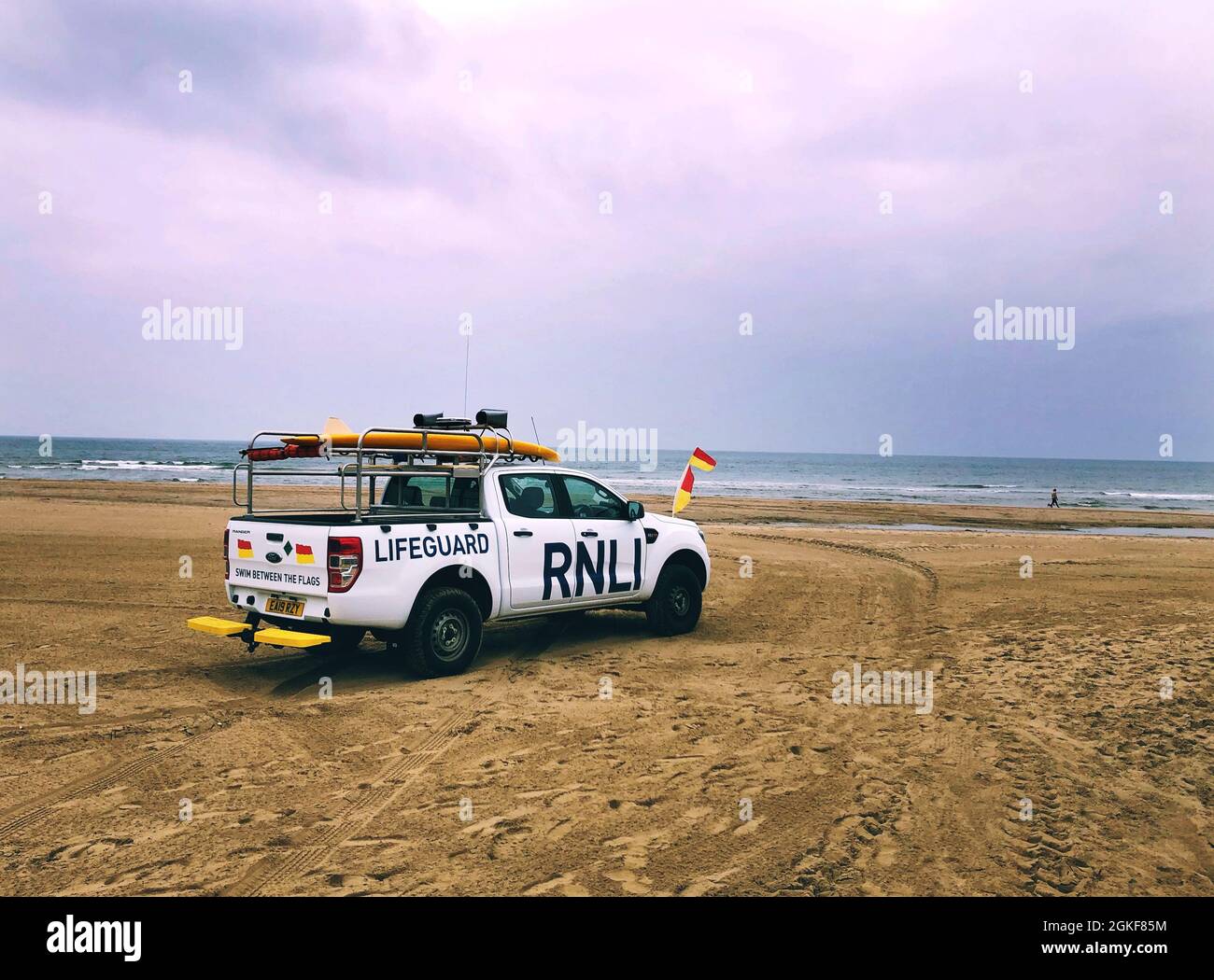 An RNLI 4 x 4 off road vehicle patrolling a British beach and seaside ...