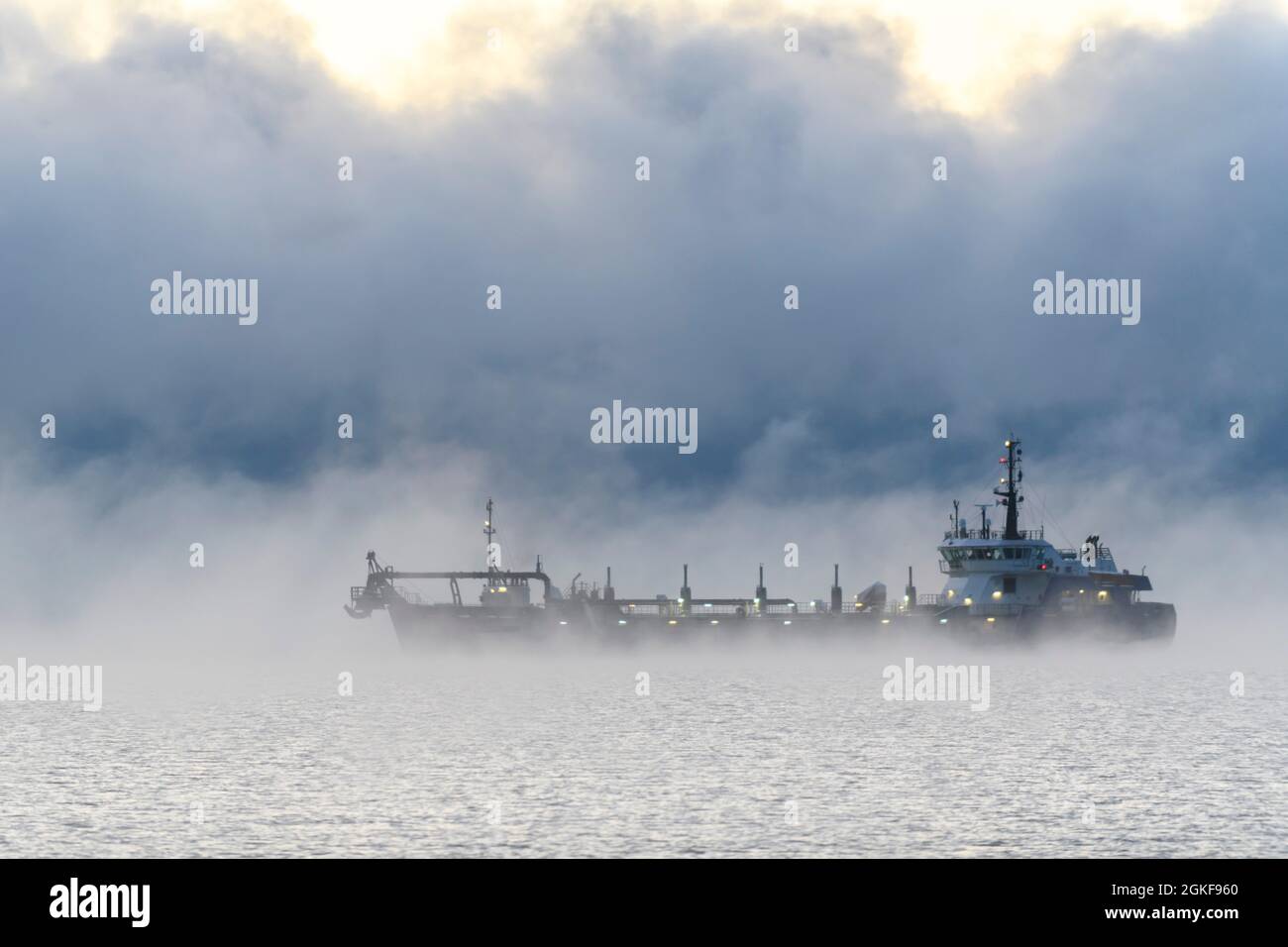 Vessel engaged in dredging. Dredger working at sea. Ship excavating ...