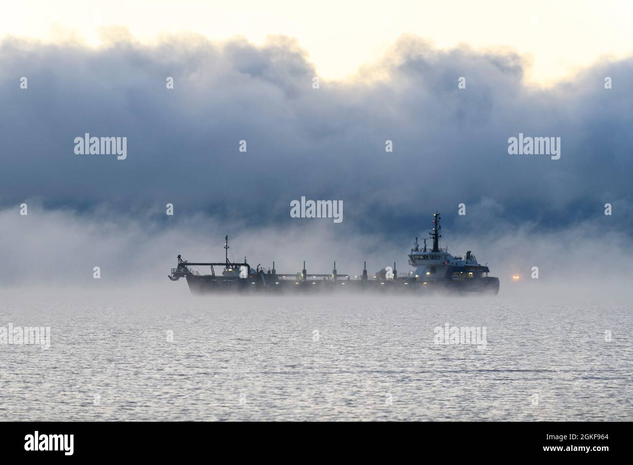 Vessel engaged in dredging. Dredger working at sea. Ship excavating ...