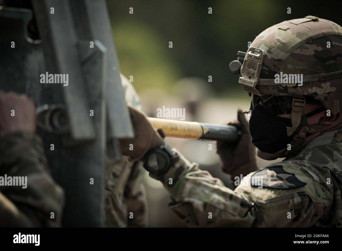 A Soldier of the 2nd Infantry Division works to construct a lines of ...