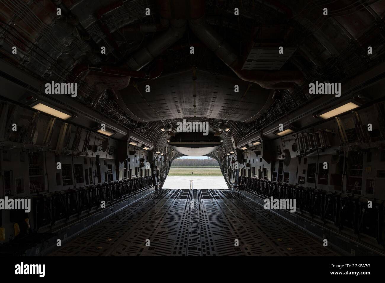 The ramp of a C-17 Globemaster III is positioned in the drive-in mode ...