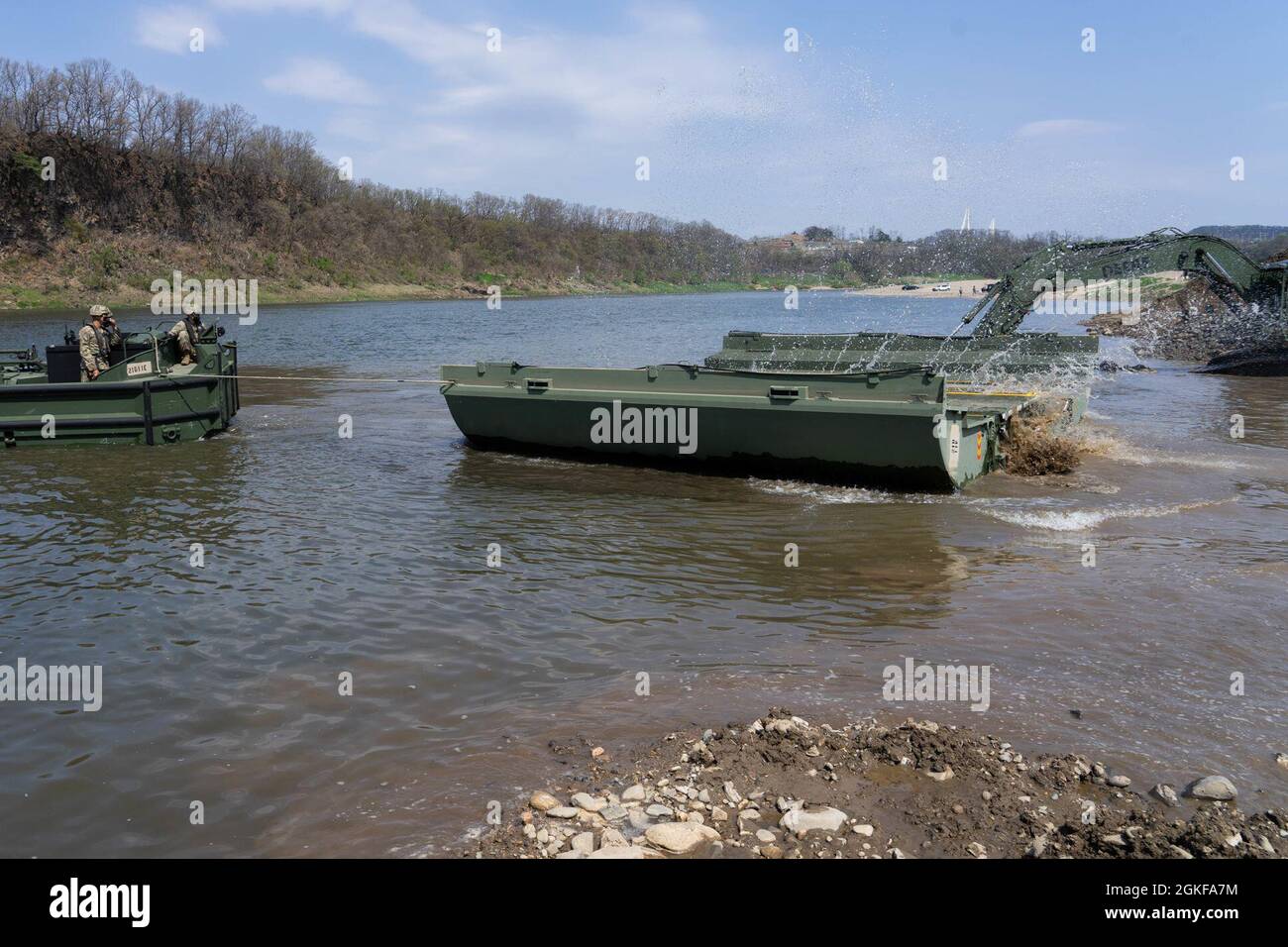 U.S. Soldiers assigned to the 2nd Infantry Division move a floating ...