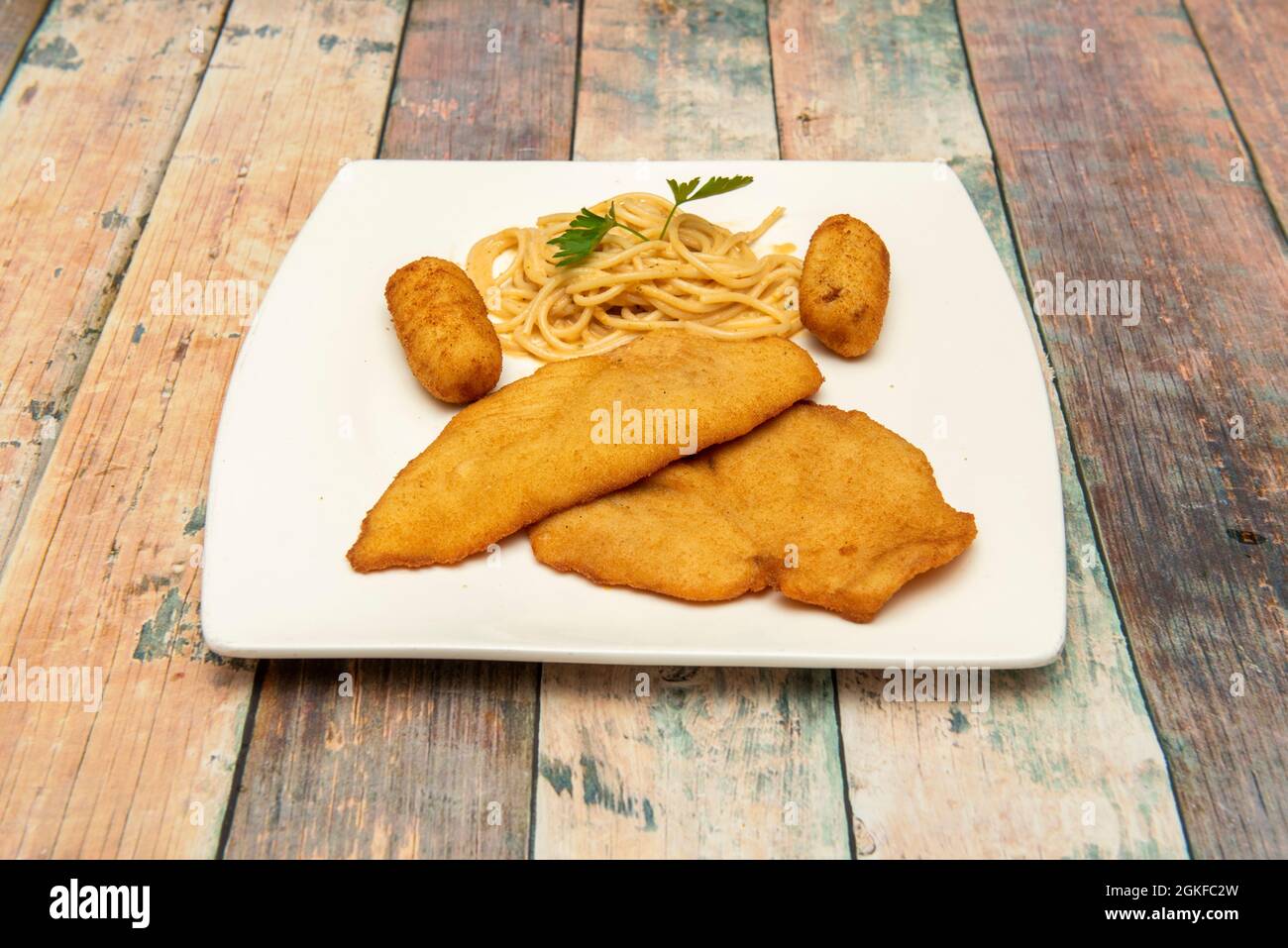 Combination dish with breaded chicken entrecote, croquettes stuffed ...