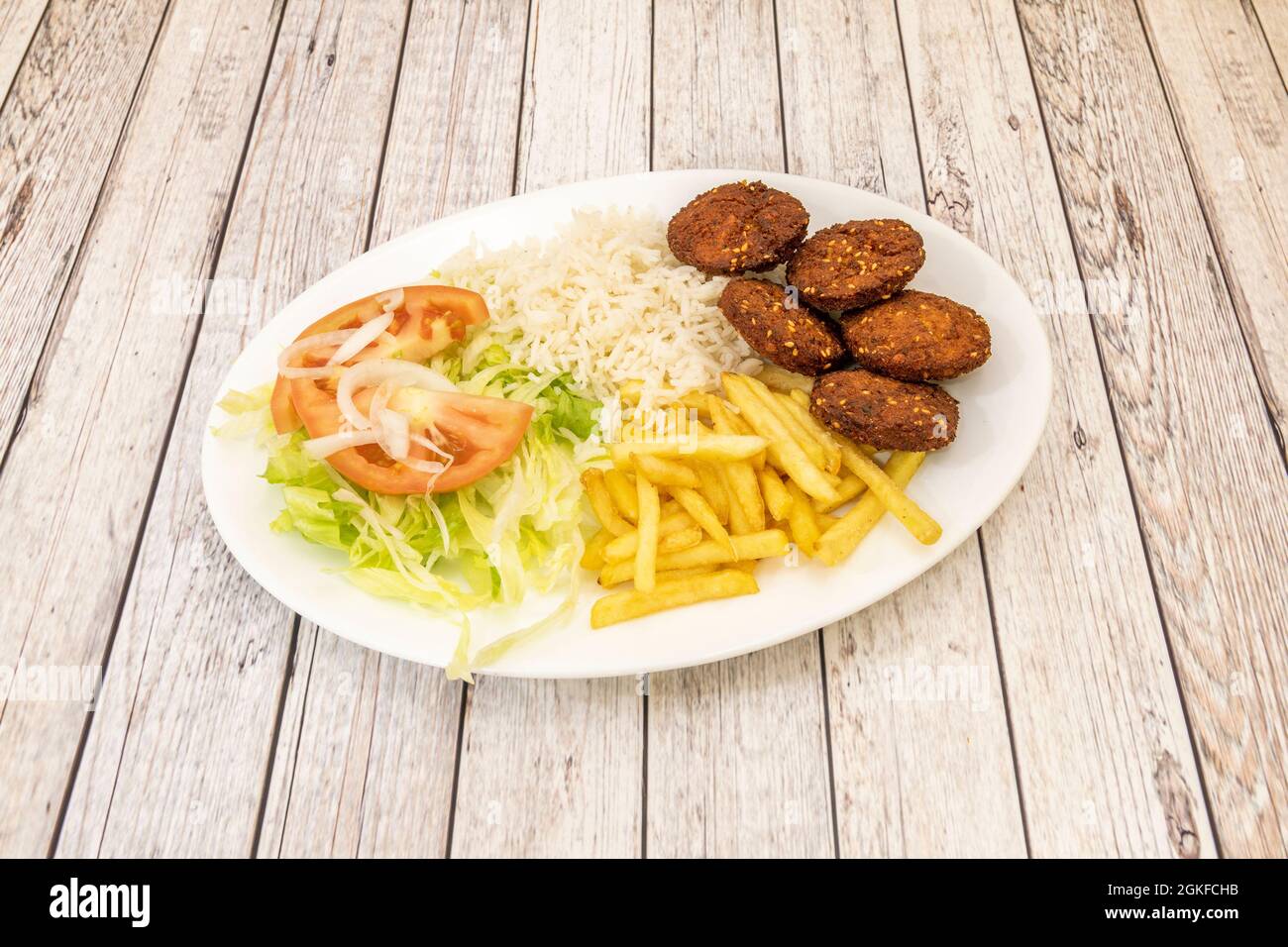 Falafel menu with balls, white rice, french fries, lettuce salad and ...