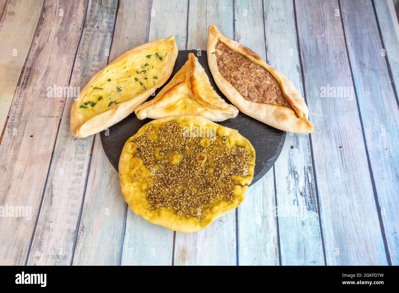 Plate with several different types of cheese fatayer, with minced lamb ...