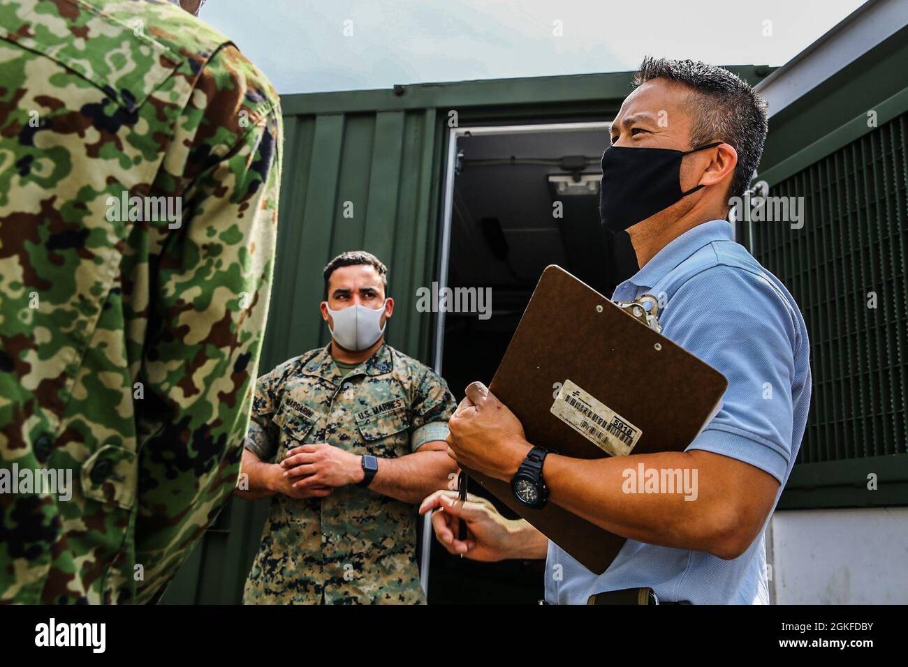 Mamoru Uriu, right, an interpreter with 3d Marine Logistics Group (MLG ...