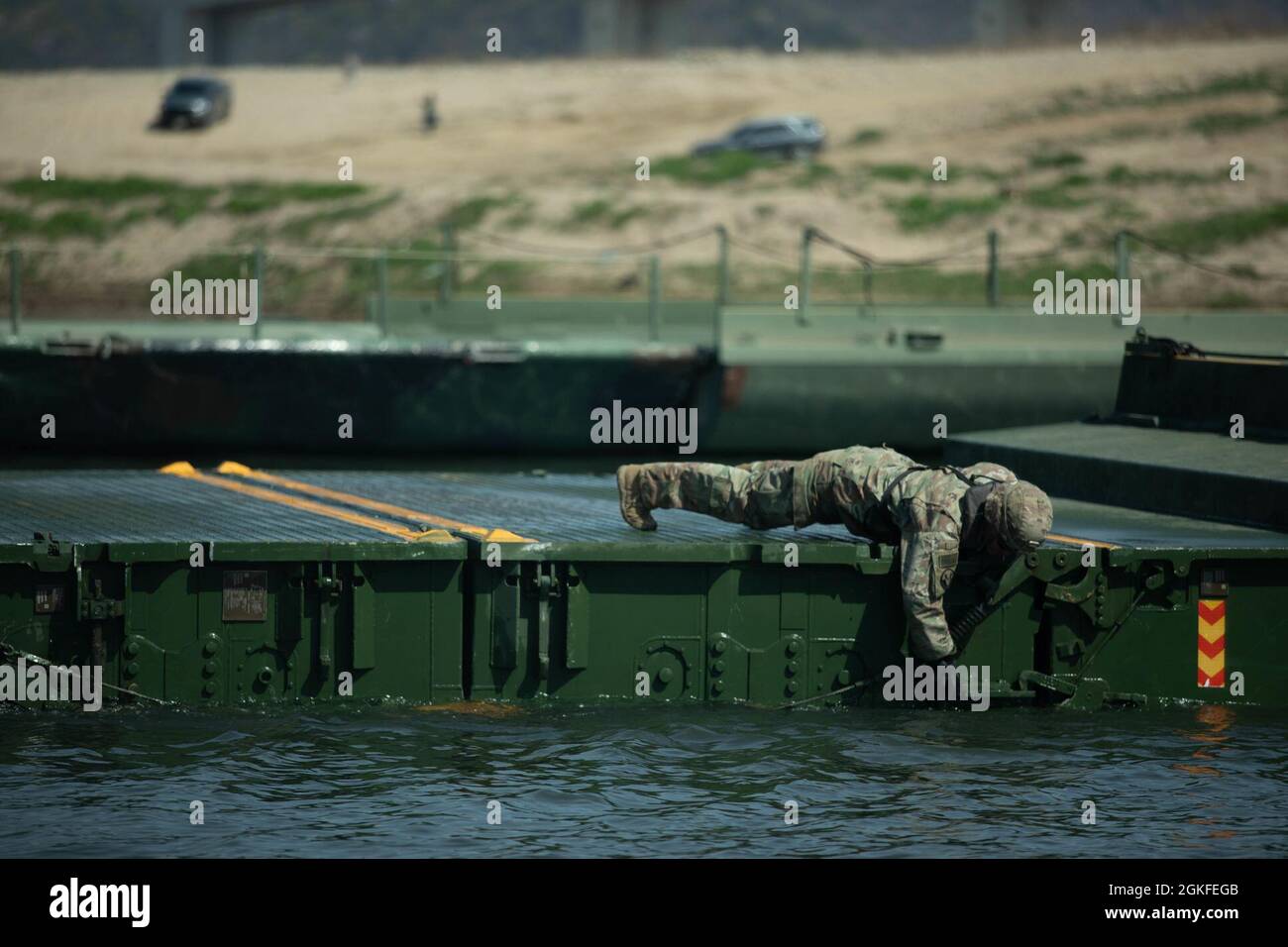 A Soldier of the 2nd Infantry Division secures locking mechanisms on ...