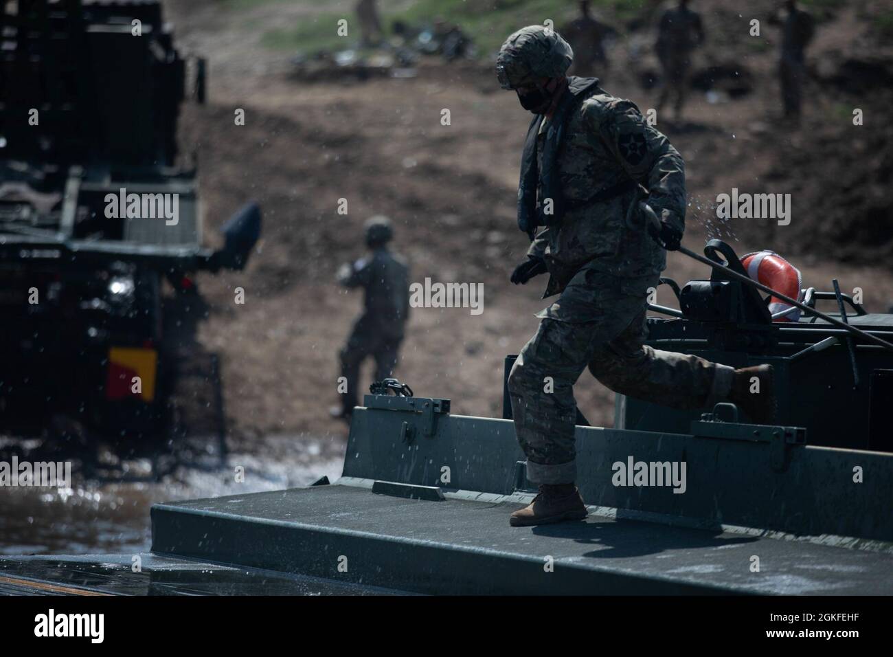 A 2nd Infantry Division Soldier prepares to tether a floating bridge ...