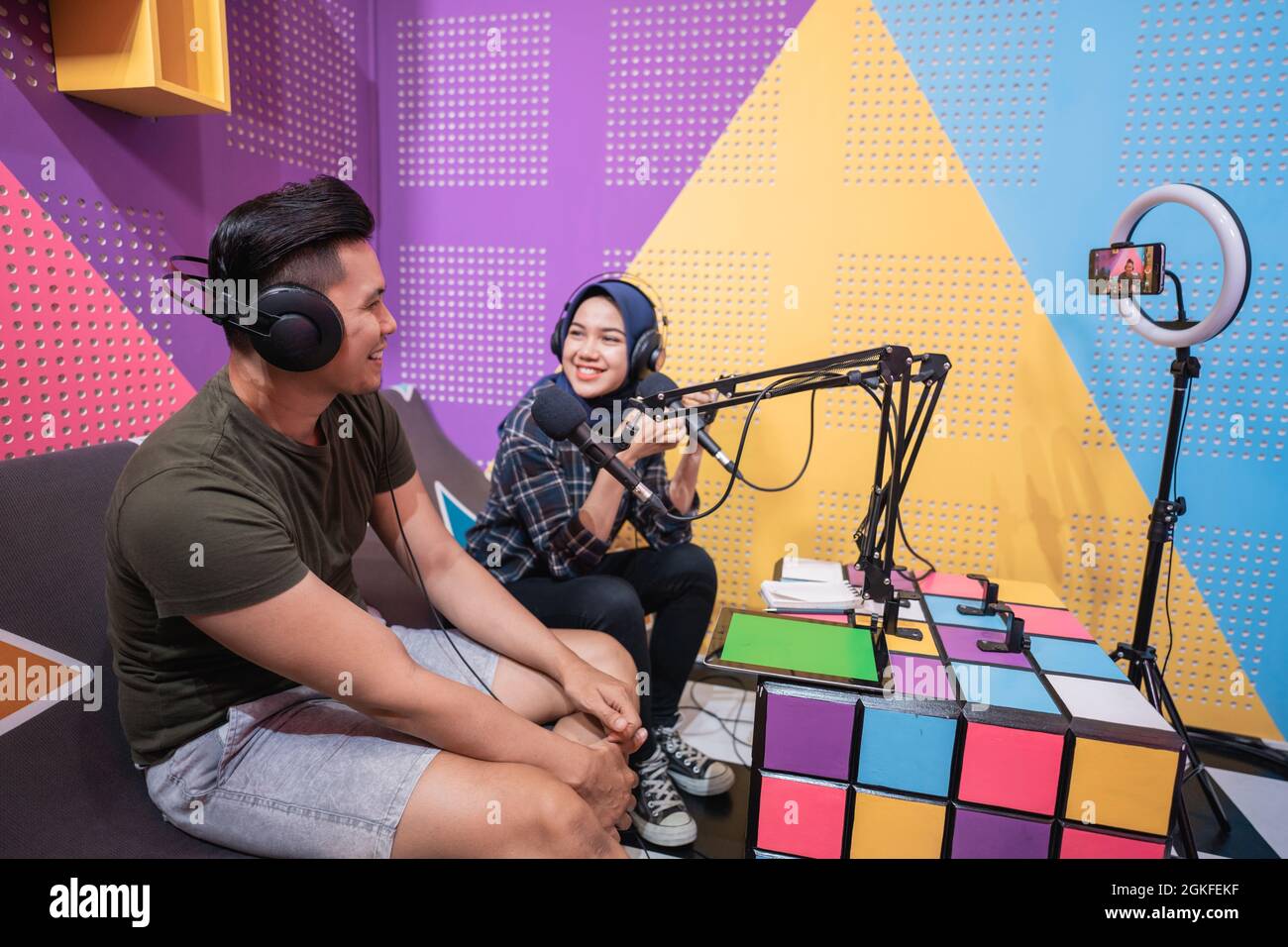 muslim asian woman and man talking on podcast studio together Stock ...