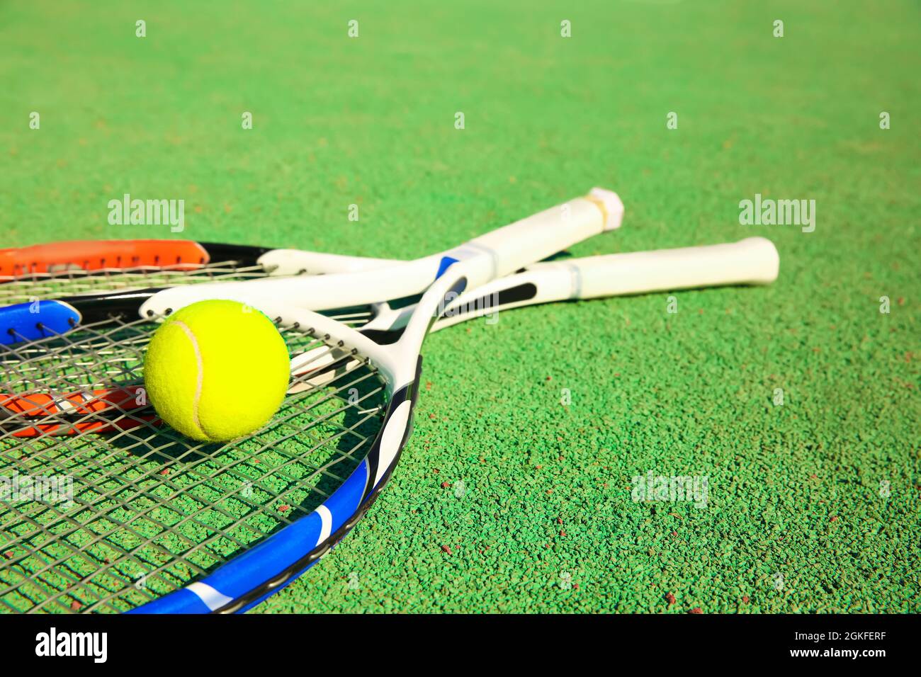 Tennis ball and rackets on court Stock Photo - Alamy