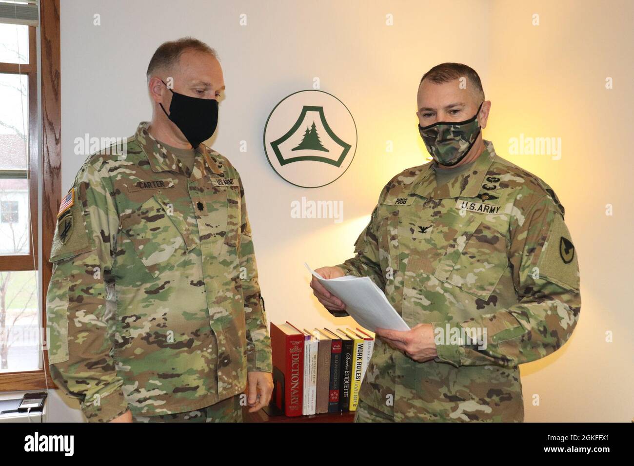 Garrison Commander Col. Michael Poss (right) congratulates Deputy ...