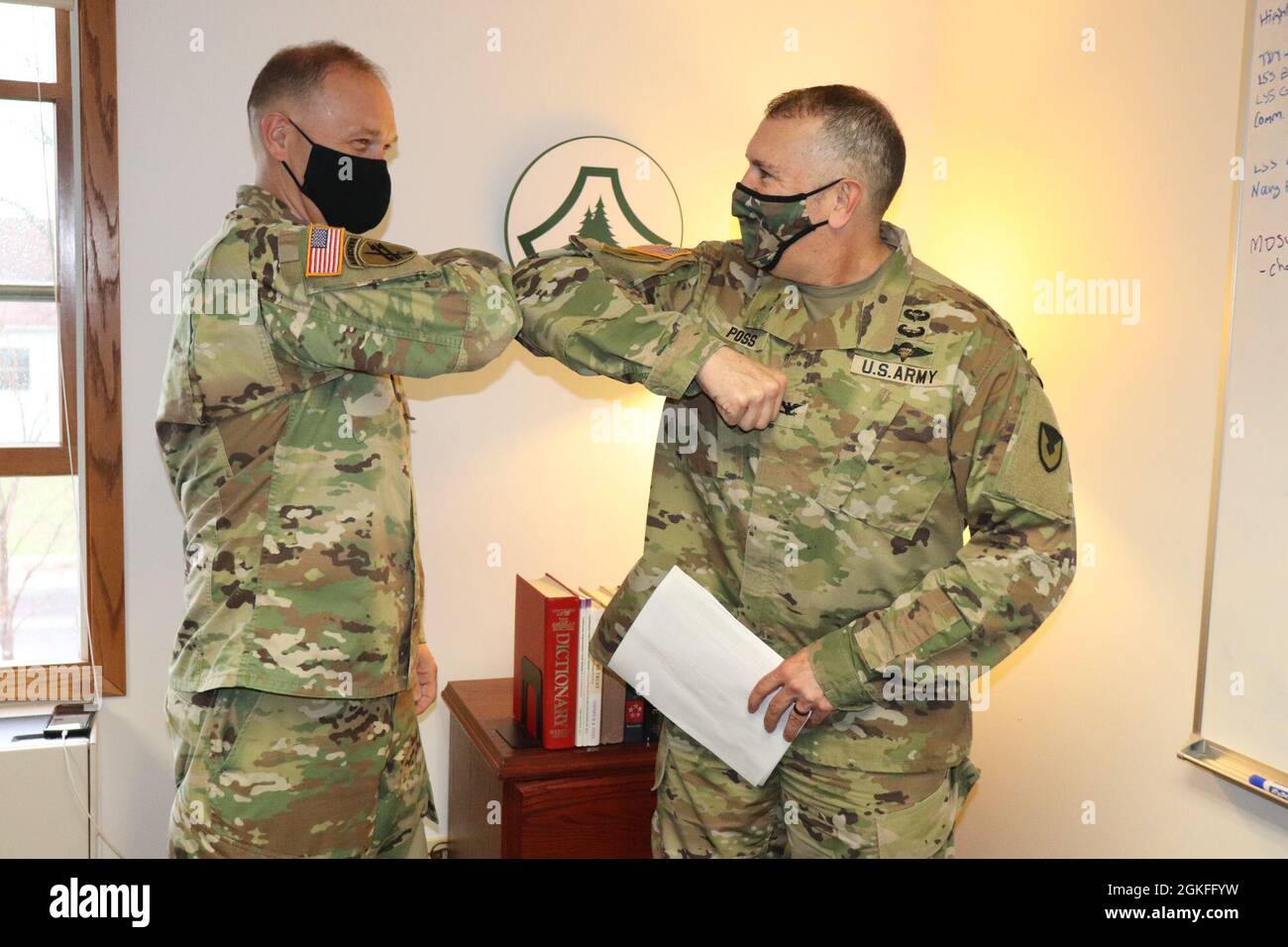 Garrison Commander Col. Michael Poss (right) congratulates Deputy ...