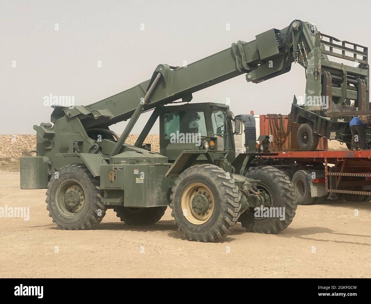 U.S. Soldiers with the 28th Expeditionary Combat Aviation Brigade load ...