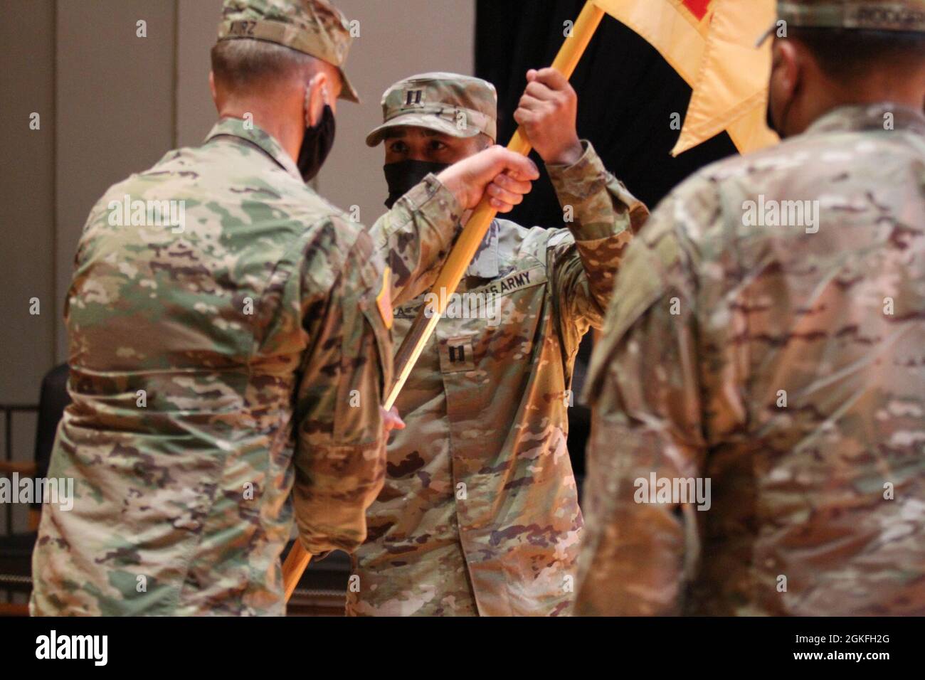 Col. Joseph Kurz, chief of staff, 1st Theater Sustainment Command, passes the company guidon to ...