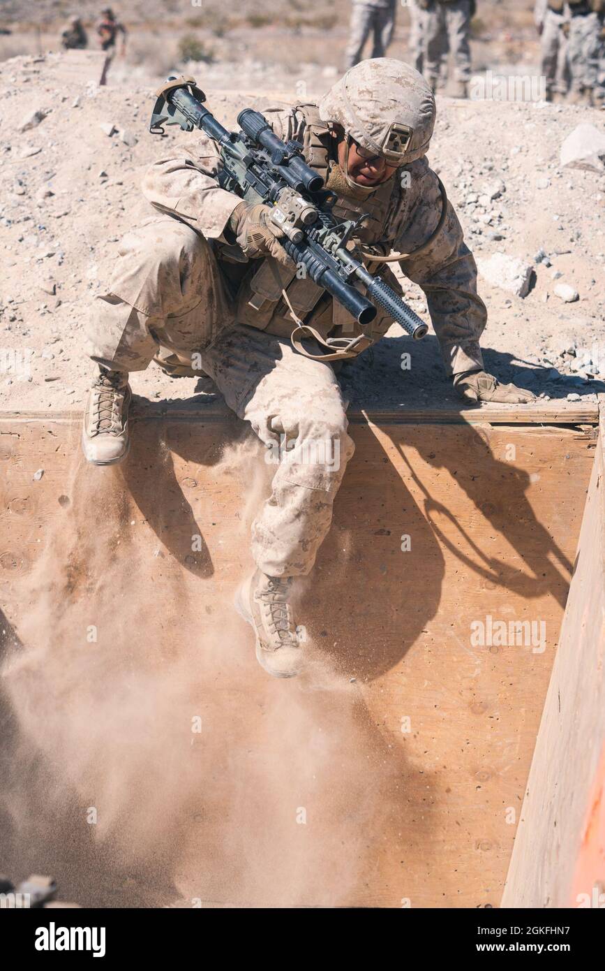 A U.S. Marine with Company B, 1st Battalion, 5th Marine Regiment, jumps ...