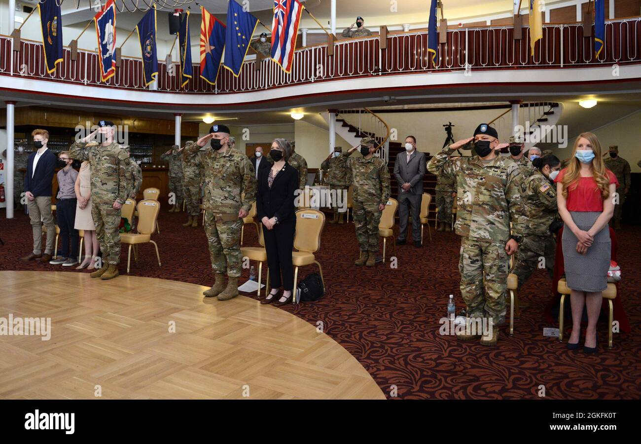 U.S. Soldiers, family and guests render honors as the U.S. and German national anthems play ...