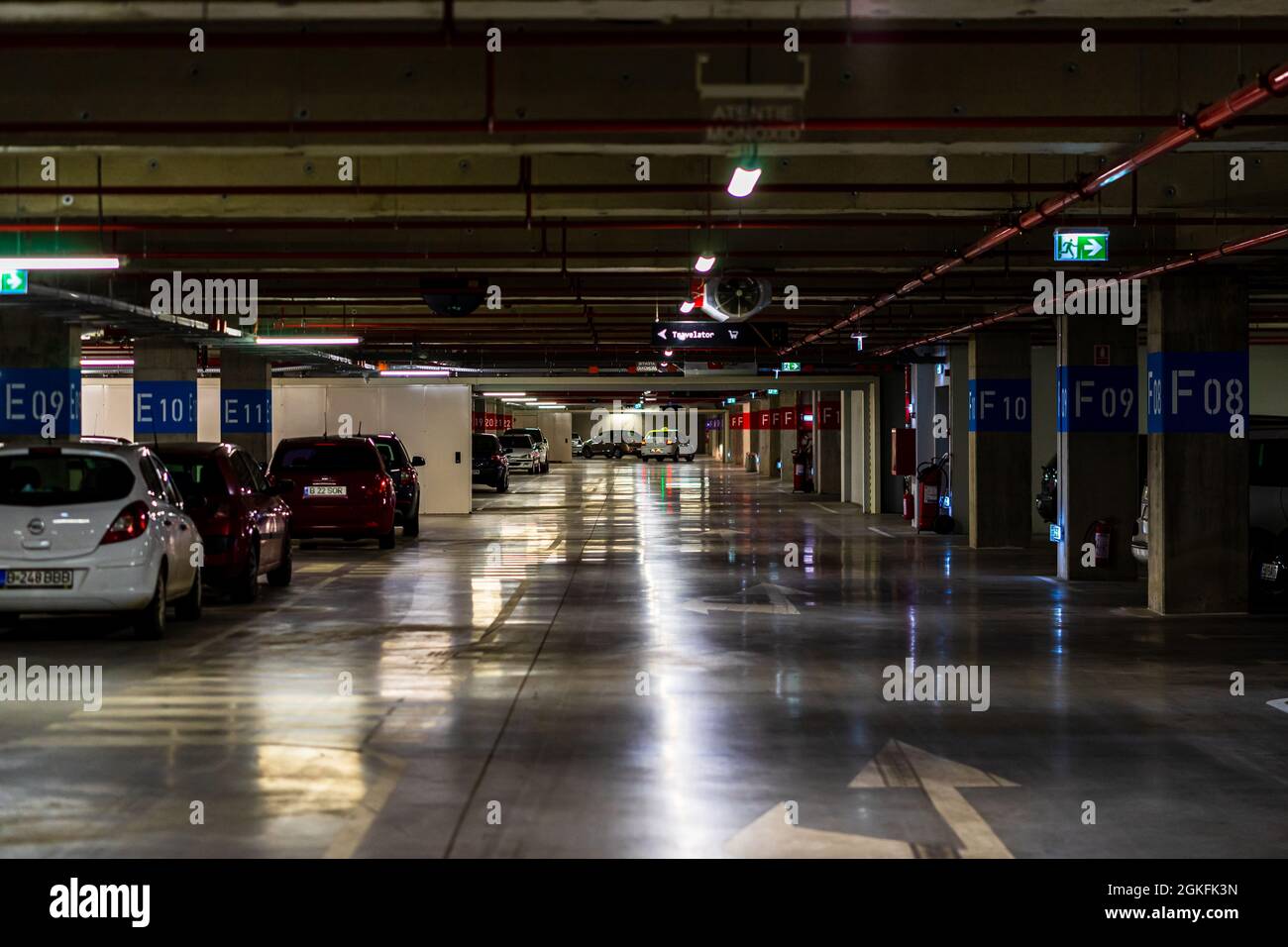 Parking garage interior with a few parked cars. Underground parking ...