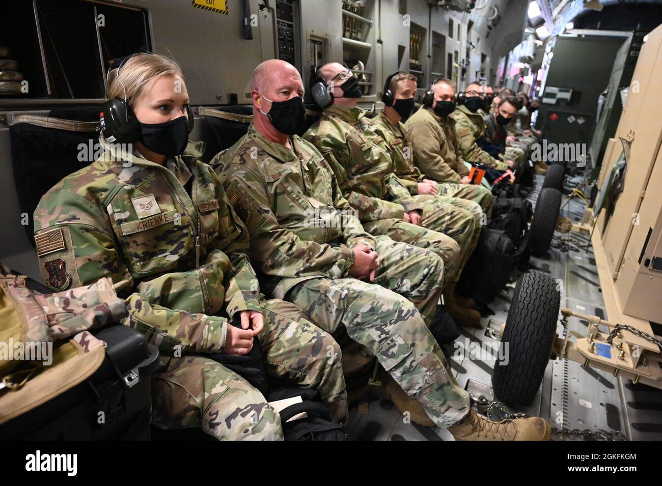 119th Wing unit members are seated on-board a C-17 aircraft as they ...