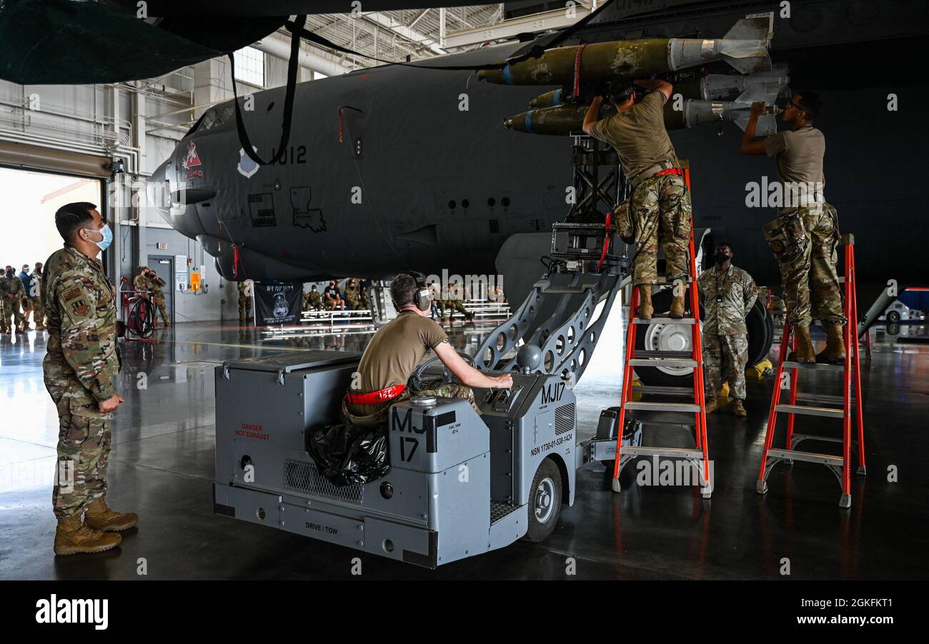 A weapons load team from the 96th Aircraft Maintenance Unit work ...
