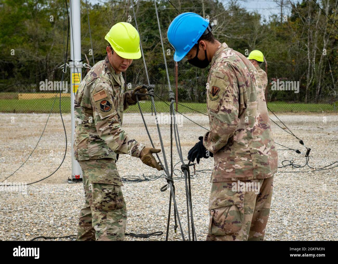 Members of the 2nd Combat Weather Systems Squadron begin to lower a ...