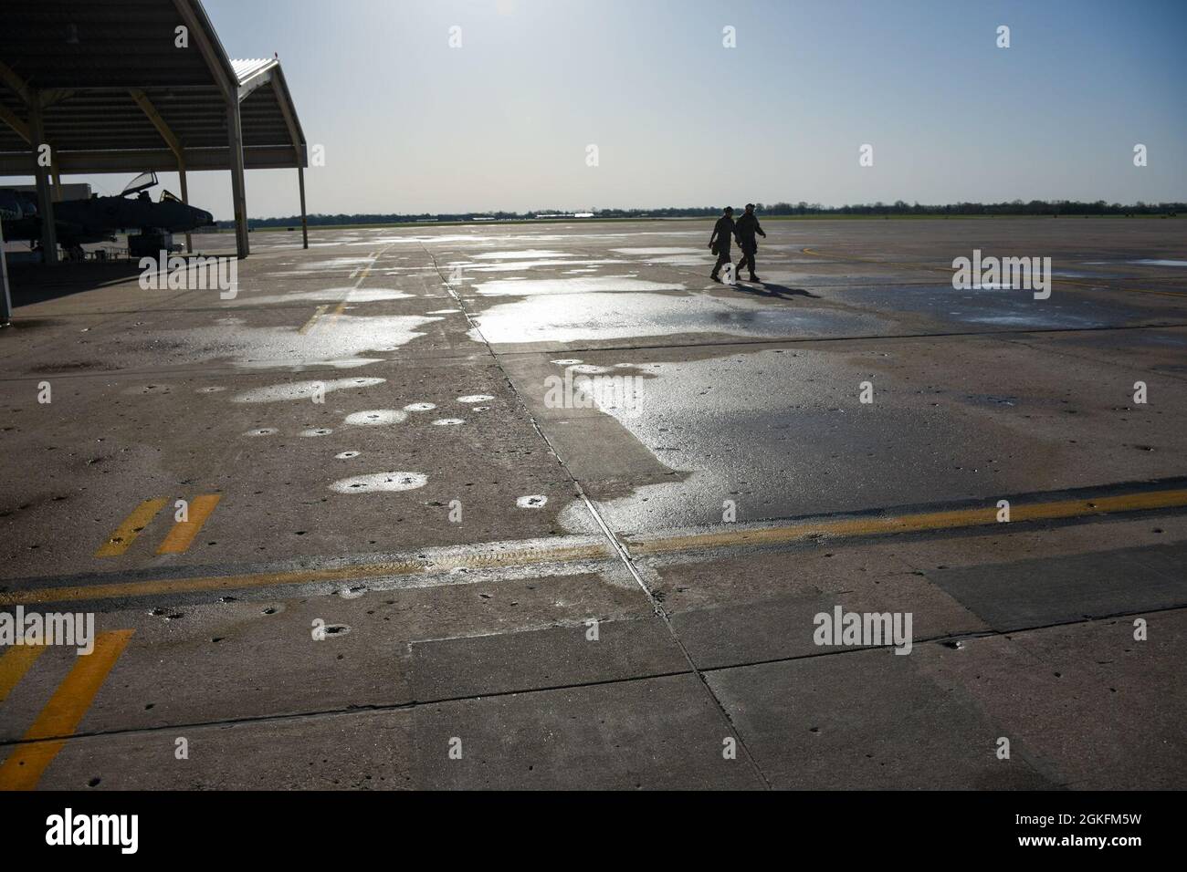 Two crew chiefs with the 442d Fighter Wing walk across the flightline ...