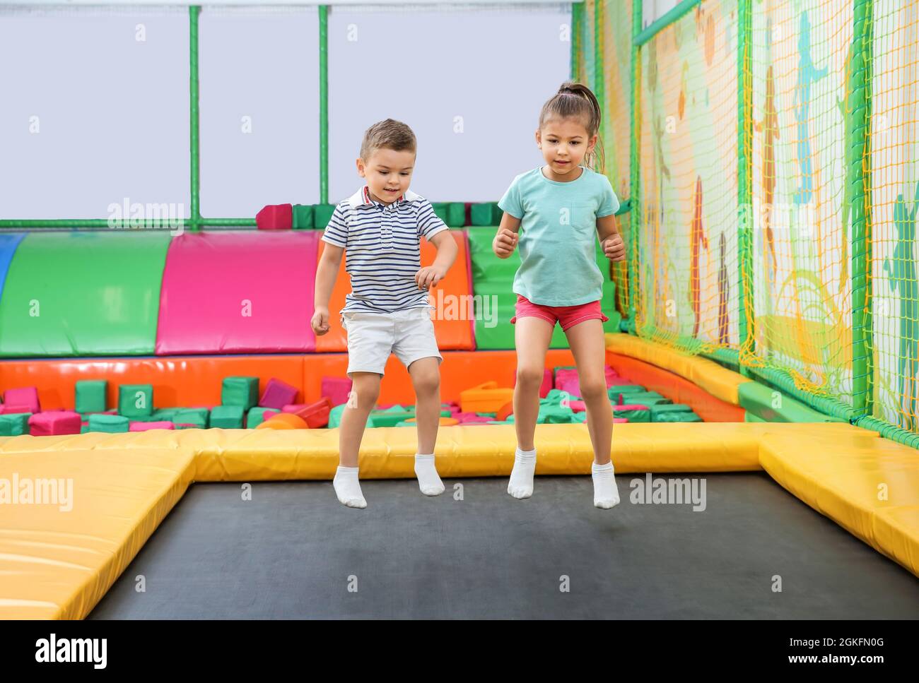 Cute children jumping on trampoline in entertainment center Stock Photo ...