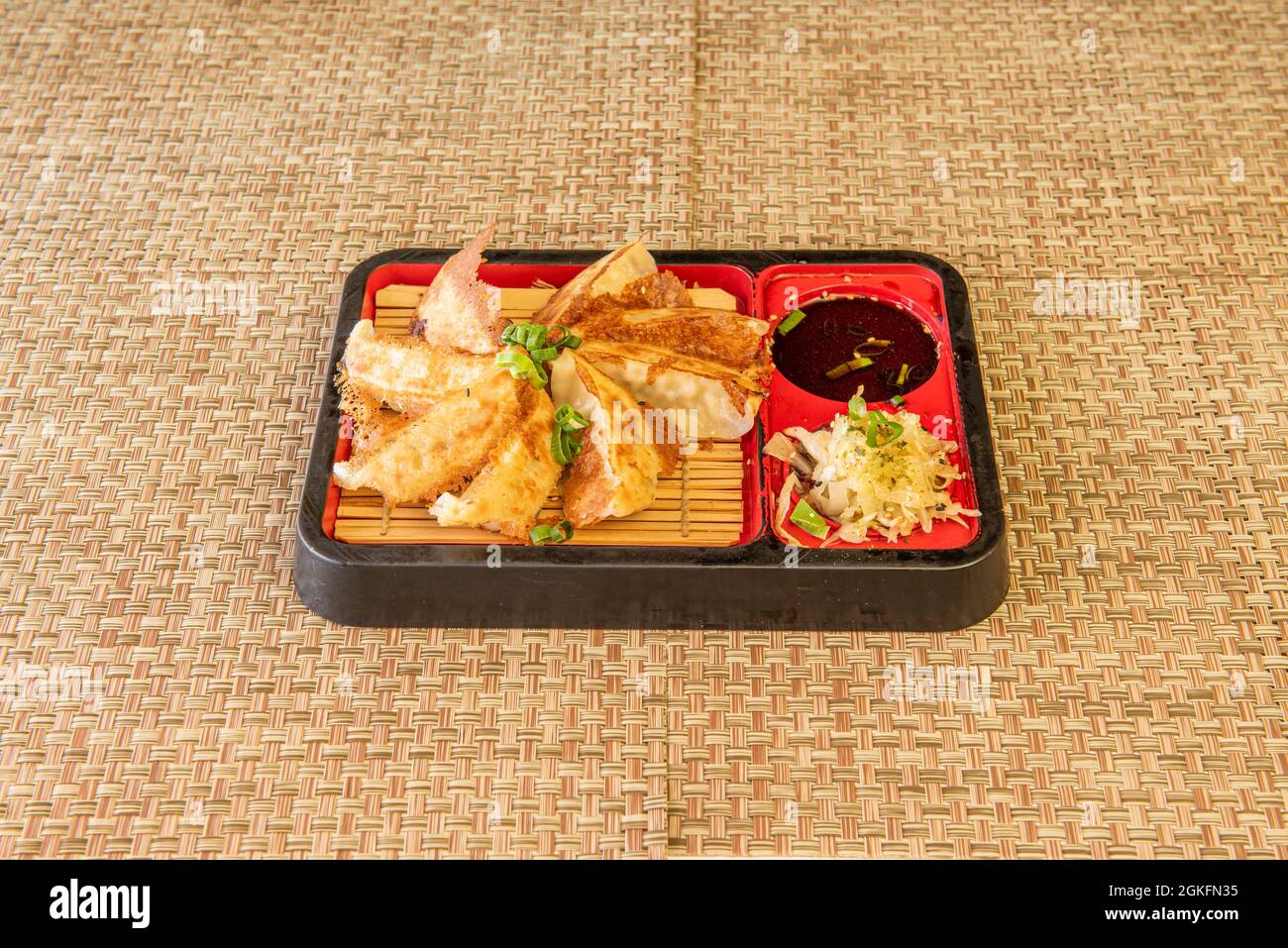Japanese menu of grilled gyoza dumplings, soy sauce and side vegetables ...
