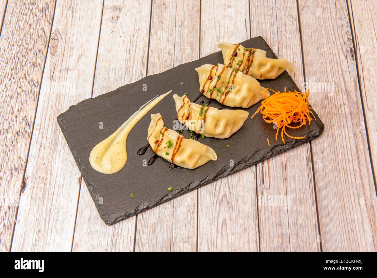 Steamed Chinese dumplings, dim sum, topped with soy sauce and carrot ...