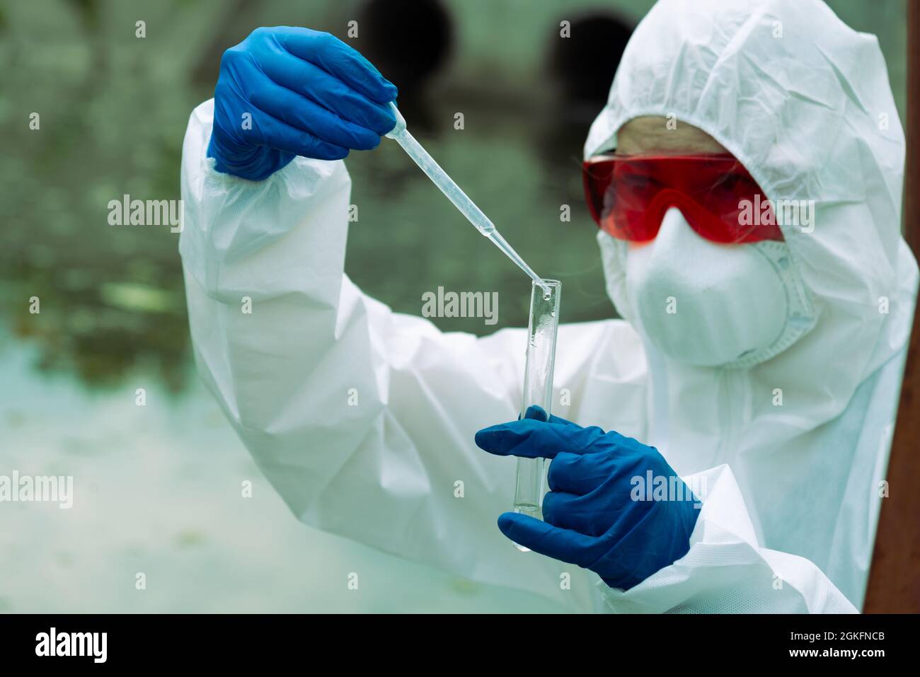 Sampling from open water. A scientist or biologist takes a water sample ...