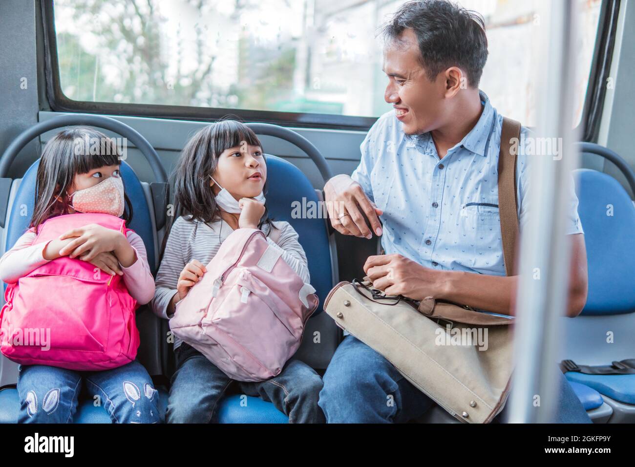 asian father taking his daughter to school by riding bus public ...