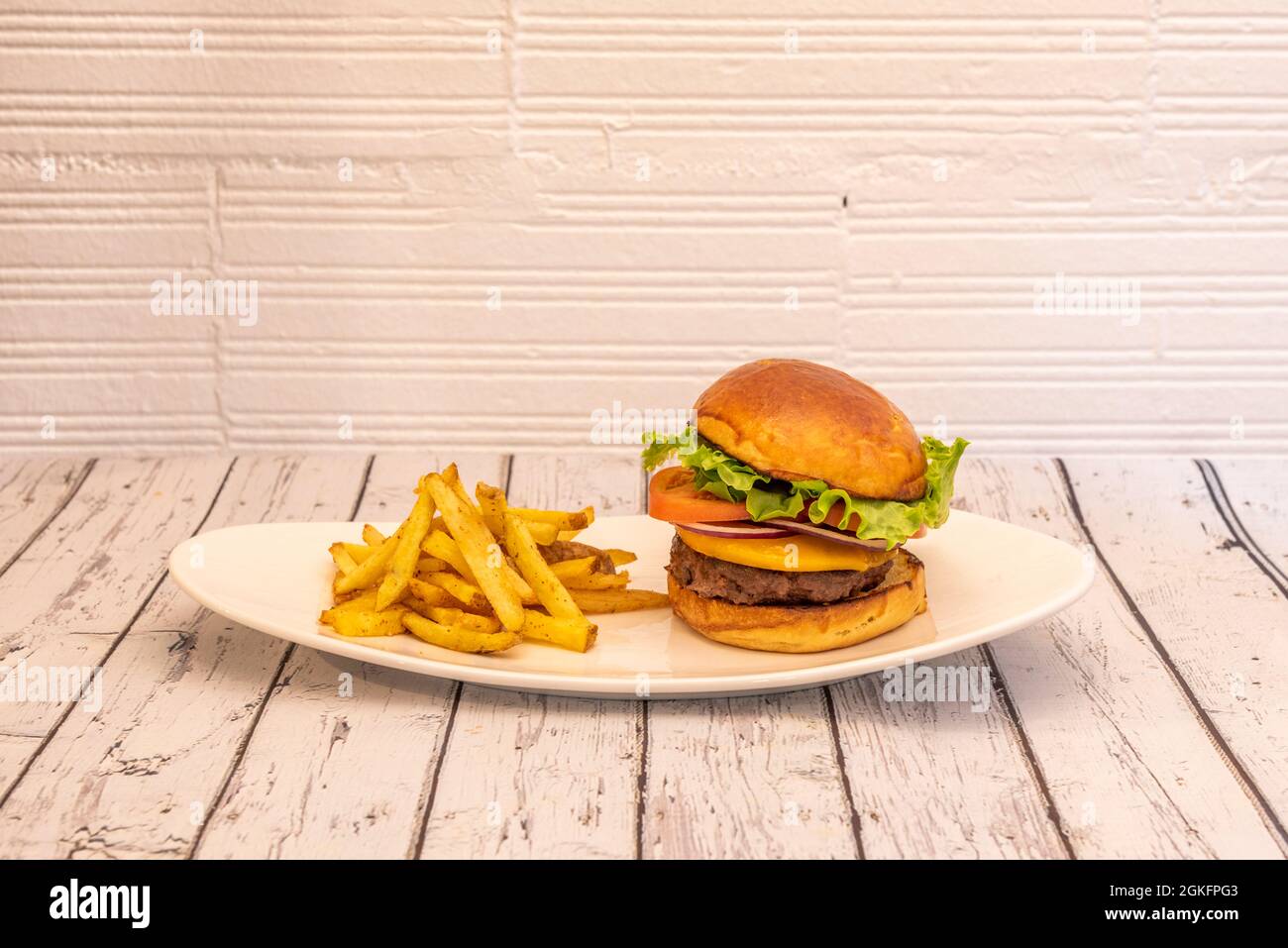 Classic beef burger with red onion, tomato slices, cheddar cheese and ...