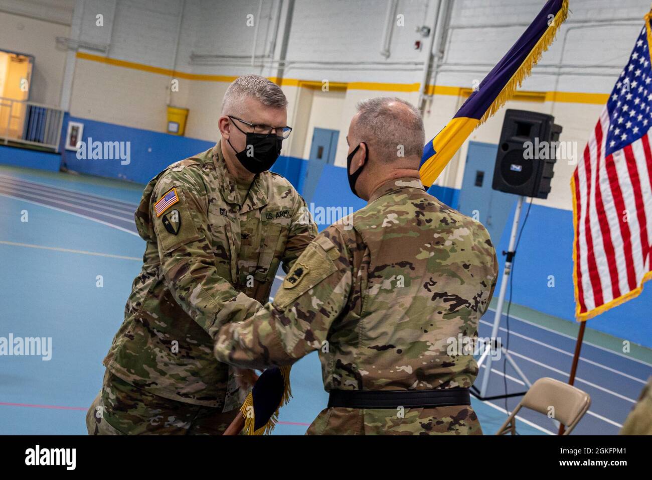 U.S. Army Col. Walter Gill, left, passes the guidon to Brig. Gen ...