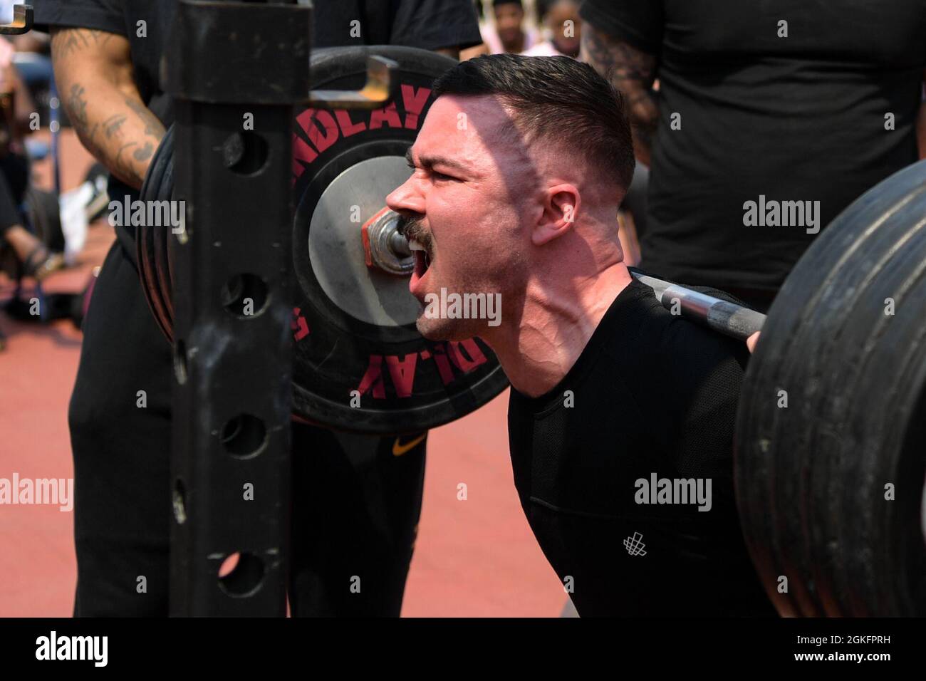 Senior Airman Tyler Sims, power lifing competitor, performs a squat ...
