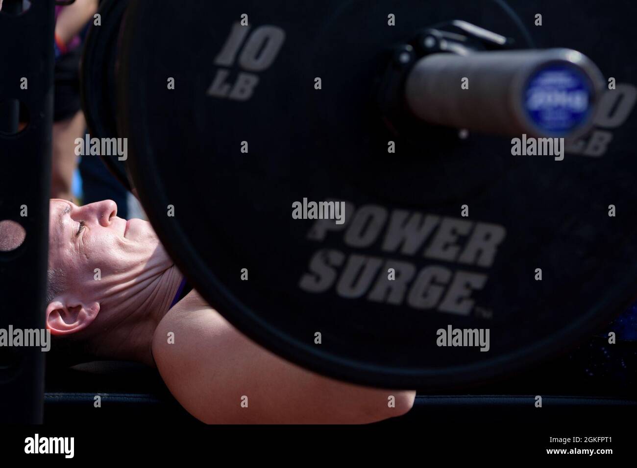 A competitor performs a bench press during a power lifting competition ...