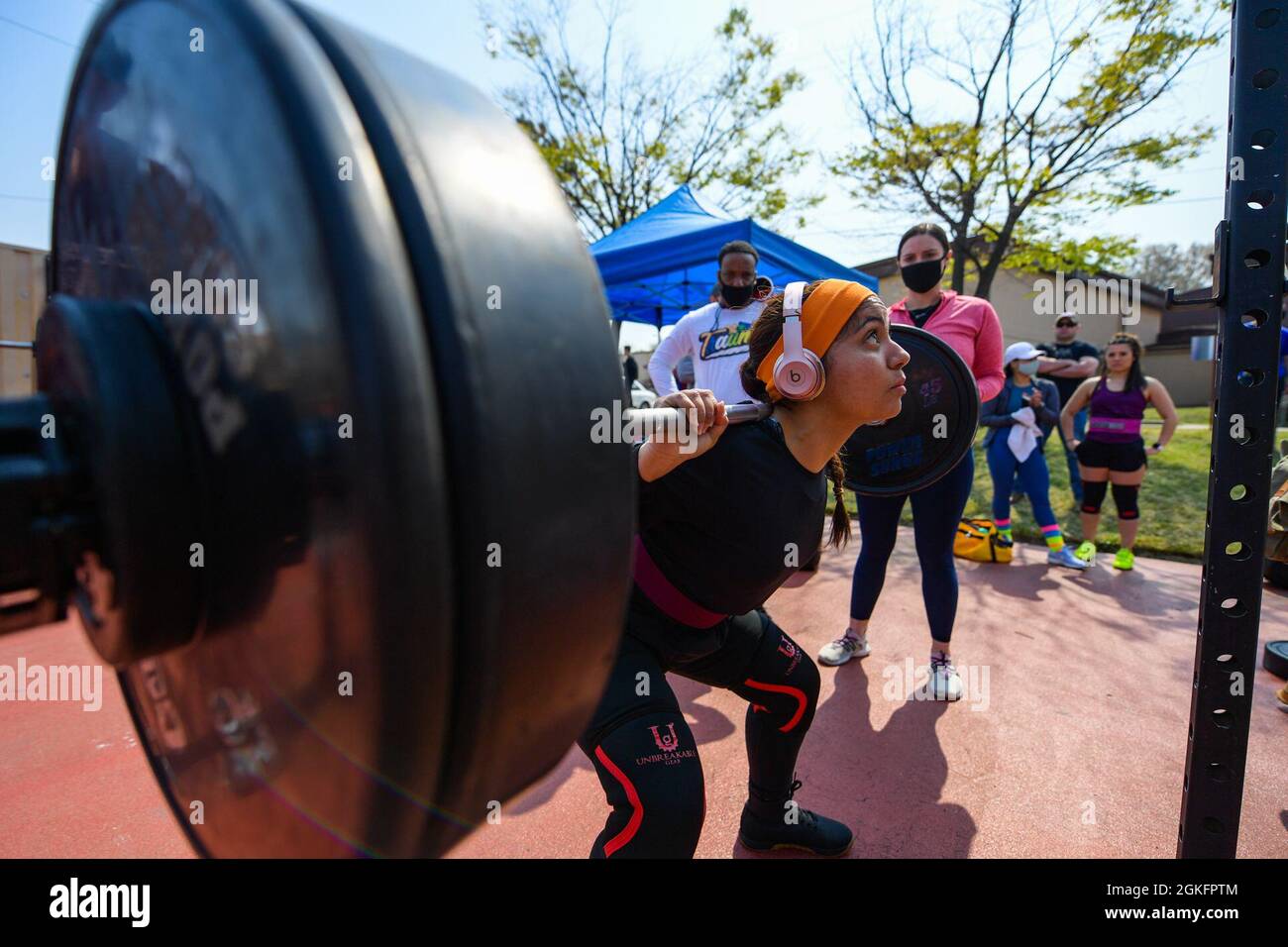 A competitor performs a squat during a power lifting competition at ...