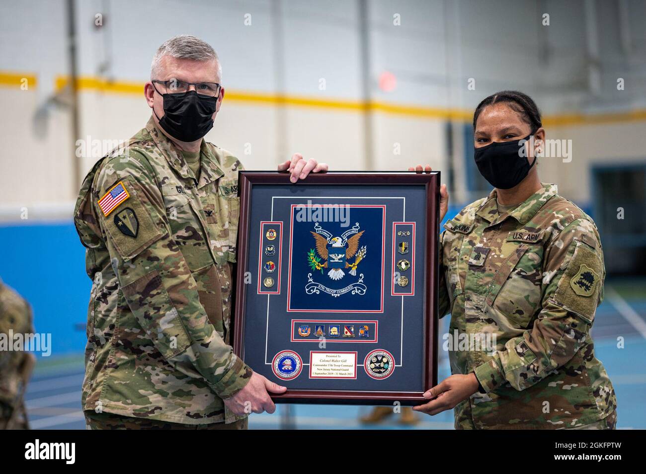 U.S. Army Col. Walter Gill, left, 57th Troop Command, receives a gift ...