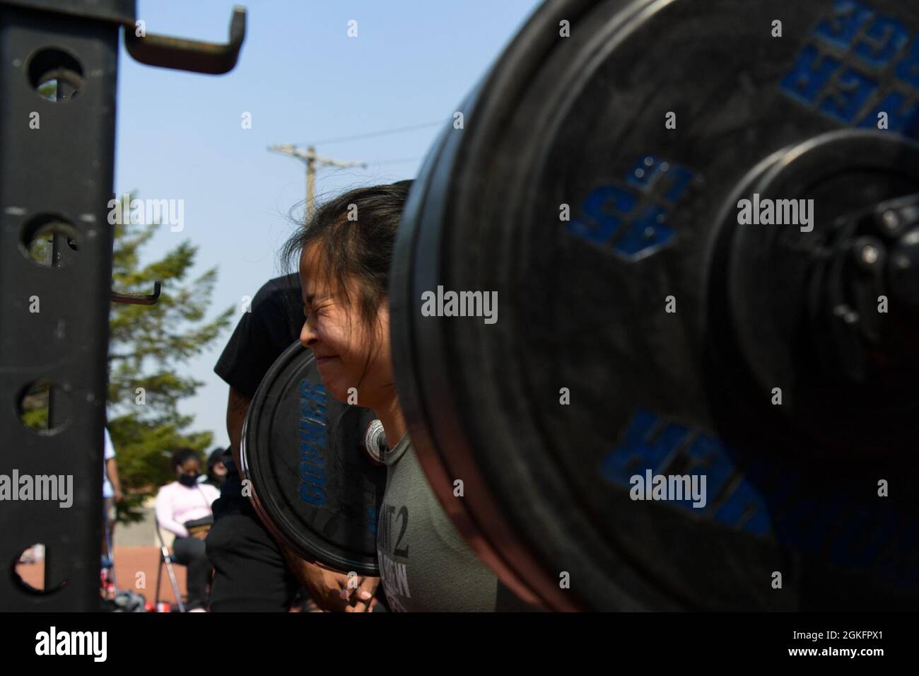 A competitor performs a squat during a power lifting competition at ...
