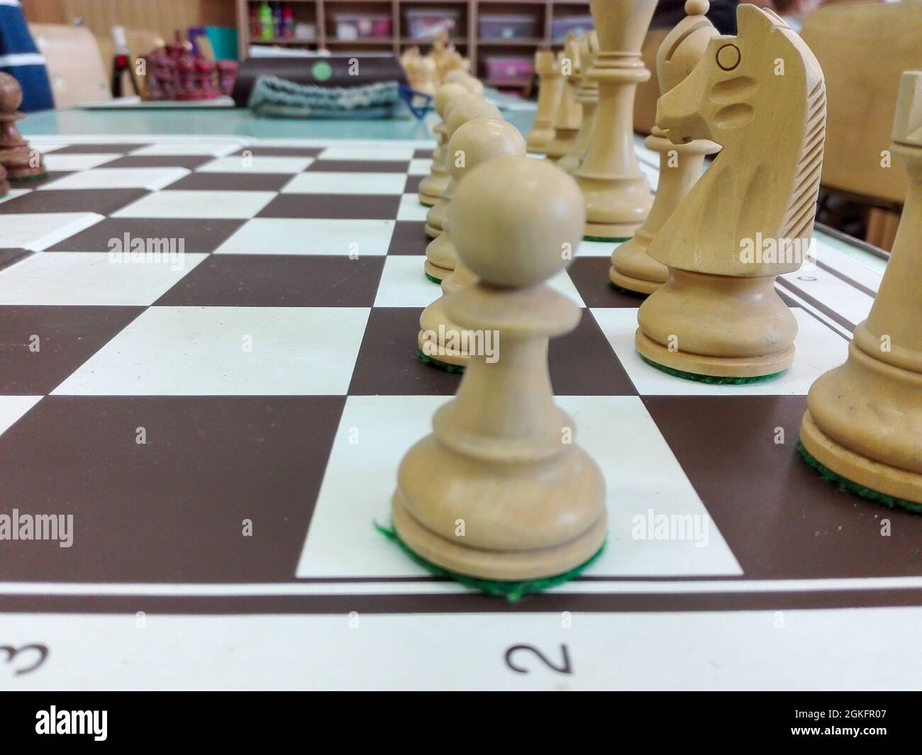 Wooden chess figurines on a chess table Stock Photo - Alamy
