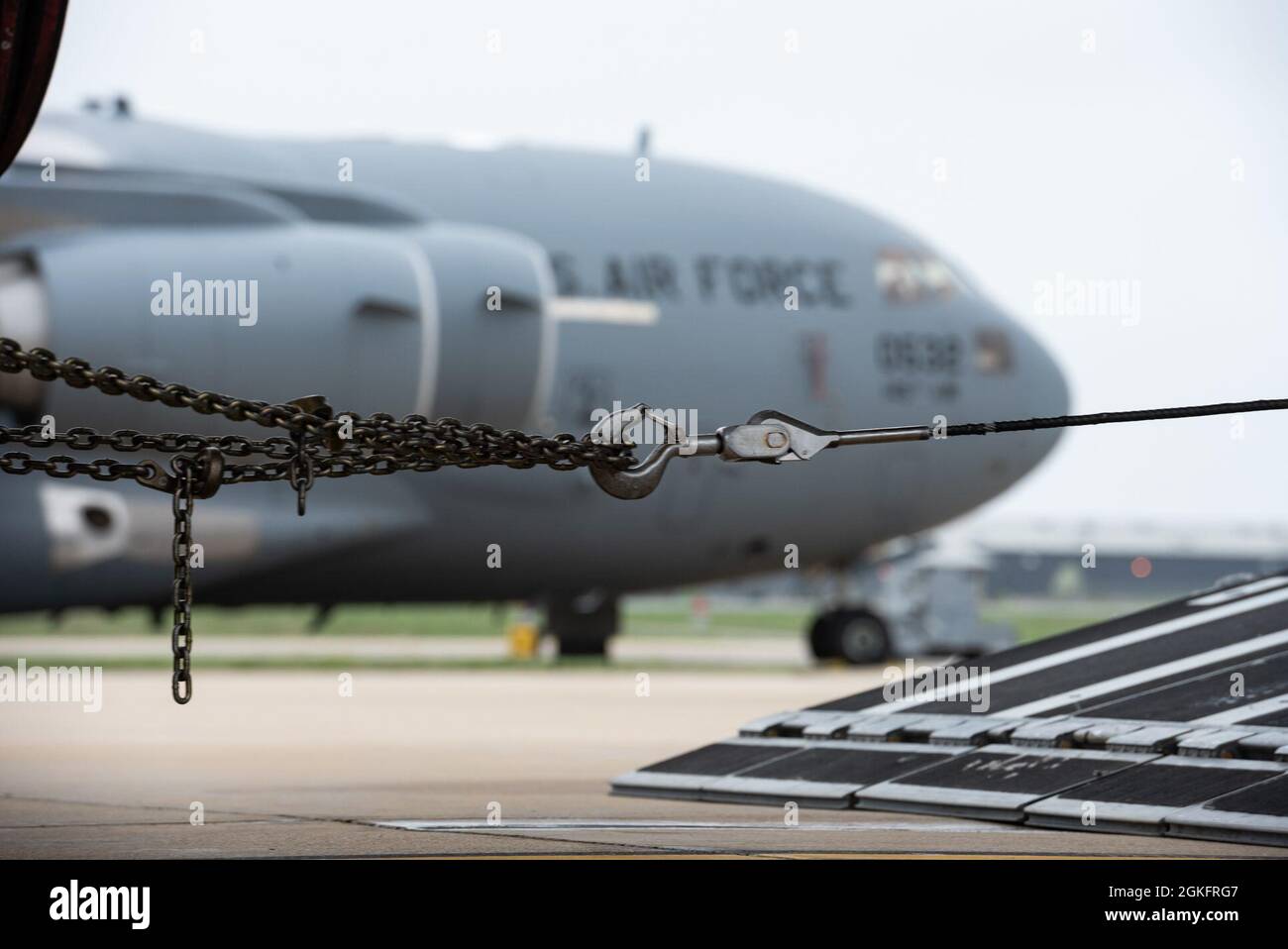 A C-17 Globemaster III aircraft winch pulls ground equipment into cargo ...