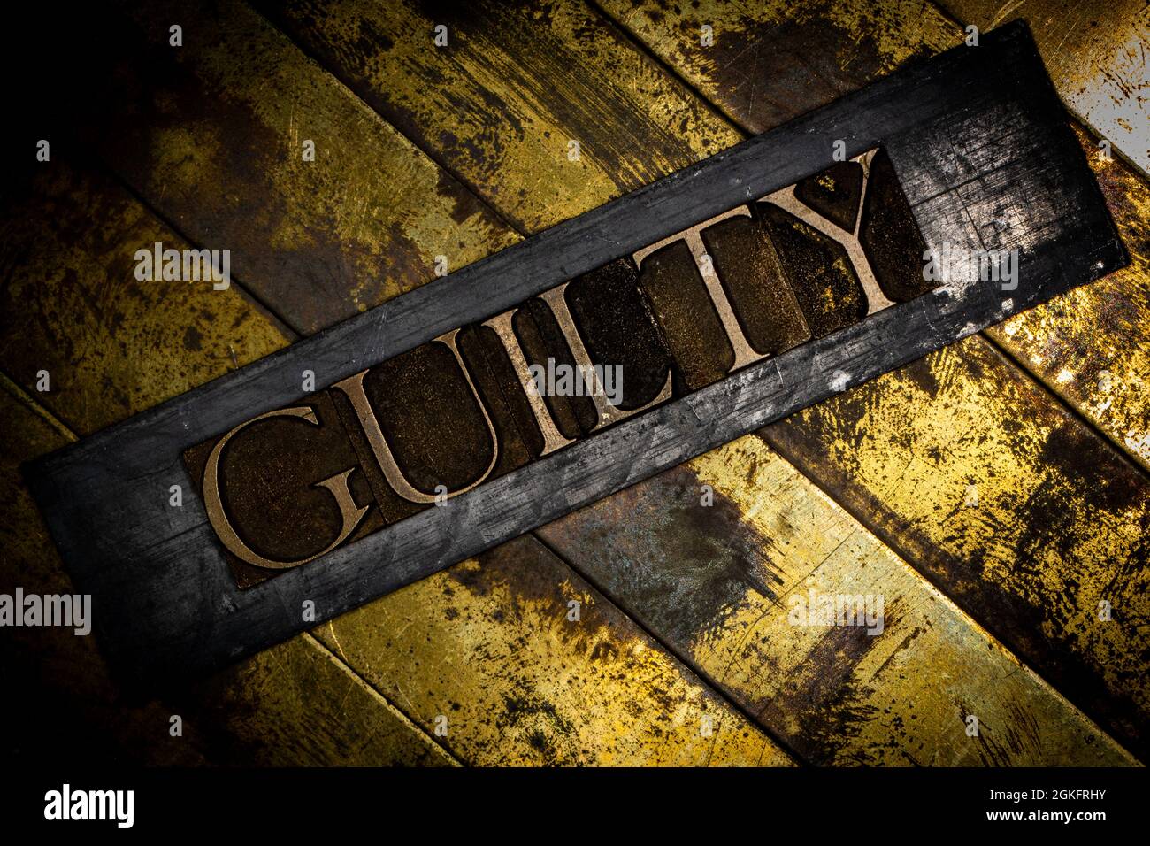 Guilty text on vintage textured copper and gold background Stock Photo ...
