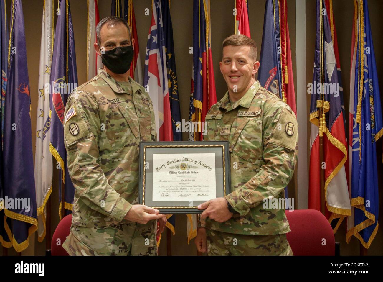 Officer Candidate Eric Hile receives a diploma from Brig. Gen. Robert ...
