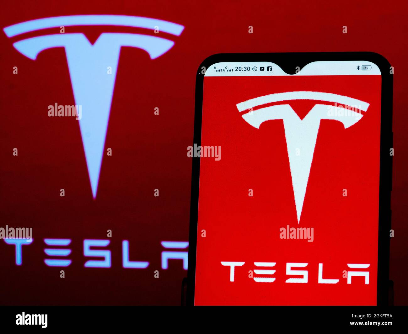 In this photo illustration Tesla, Inc. logo seen displayed on a ...