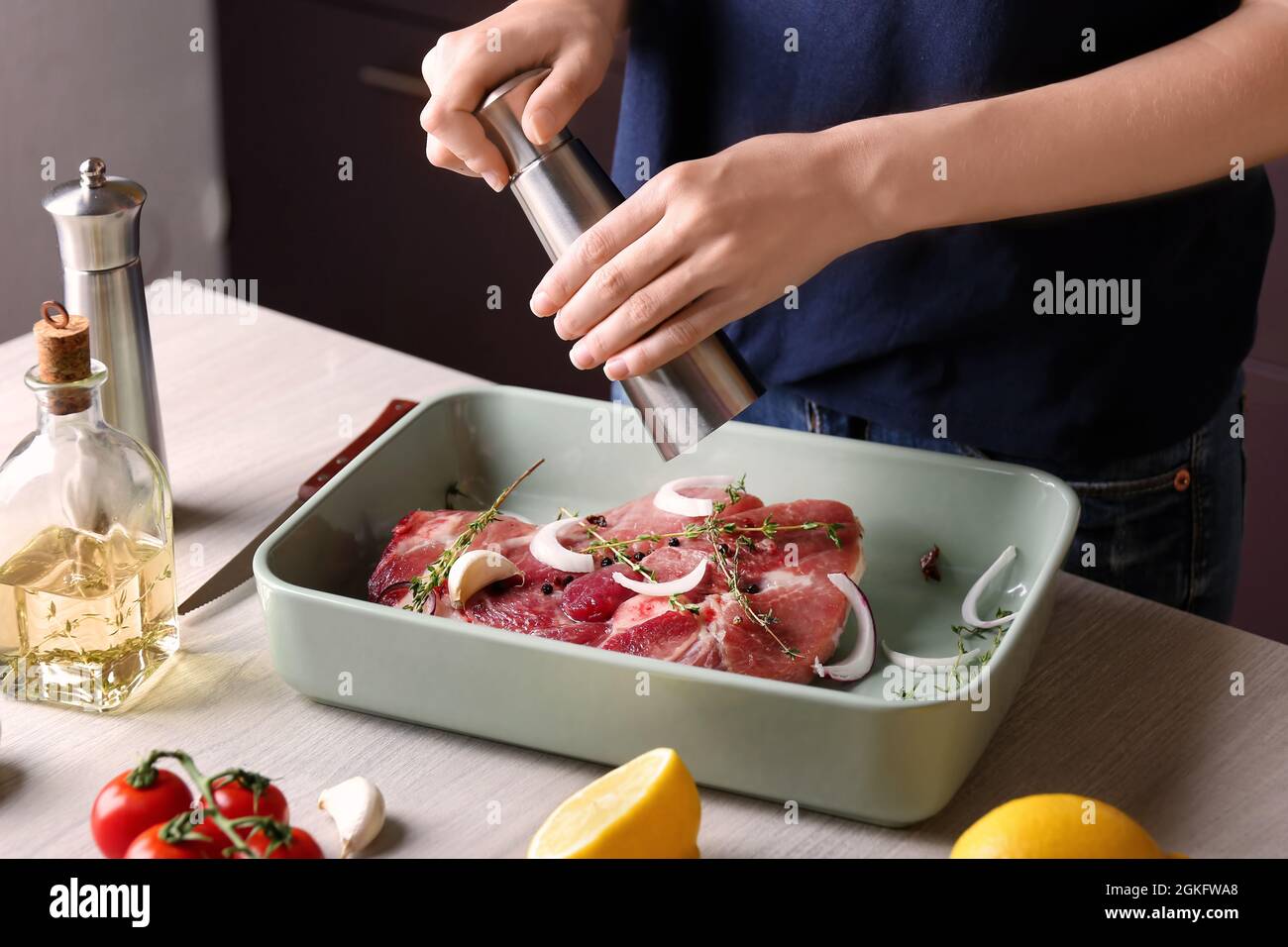 Woman cooking steak in kitchen Stock Photo - Alamy