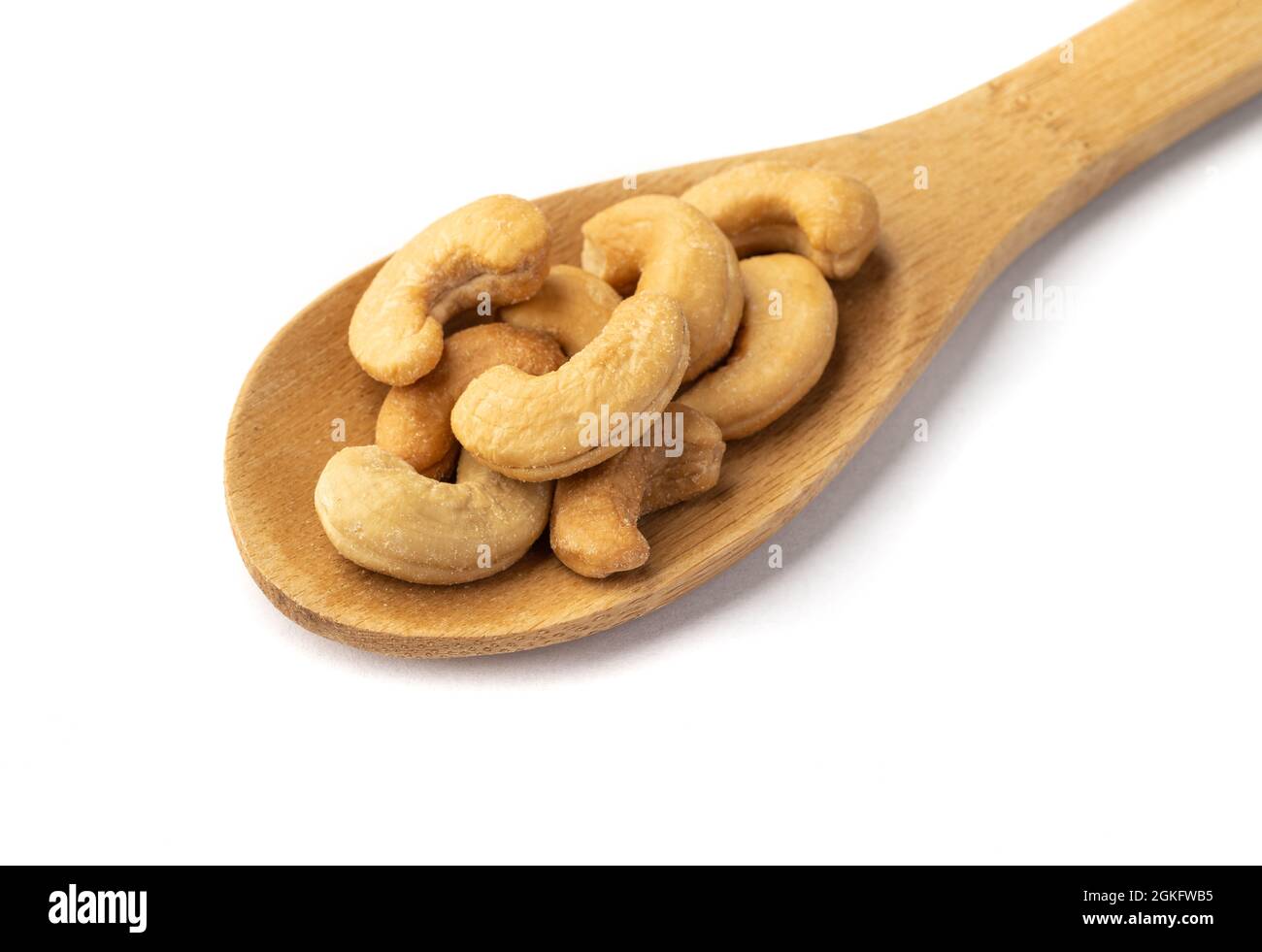 Cashew nuts in a wooden spoon isolated over white background Stock ...