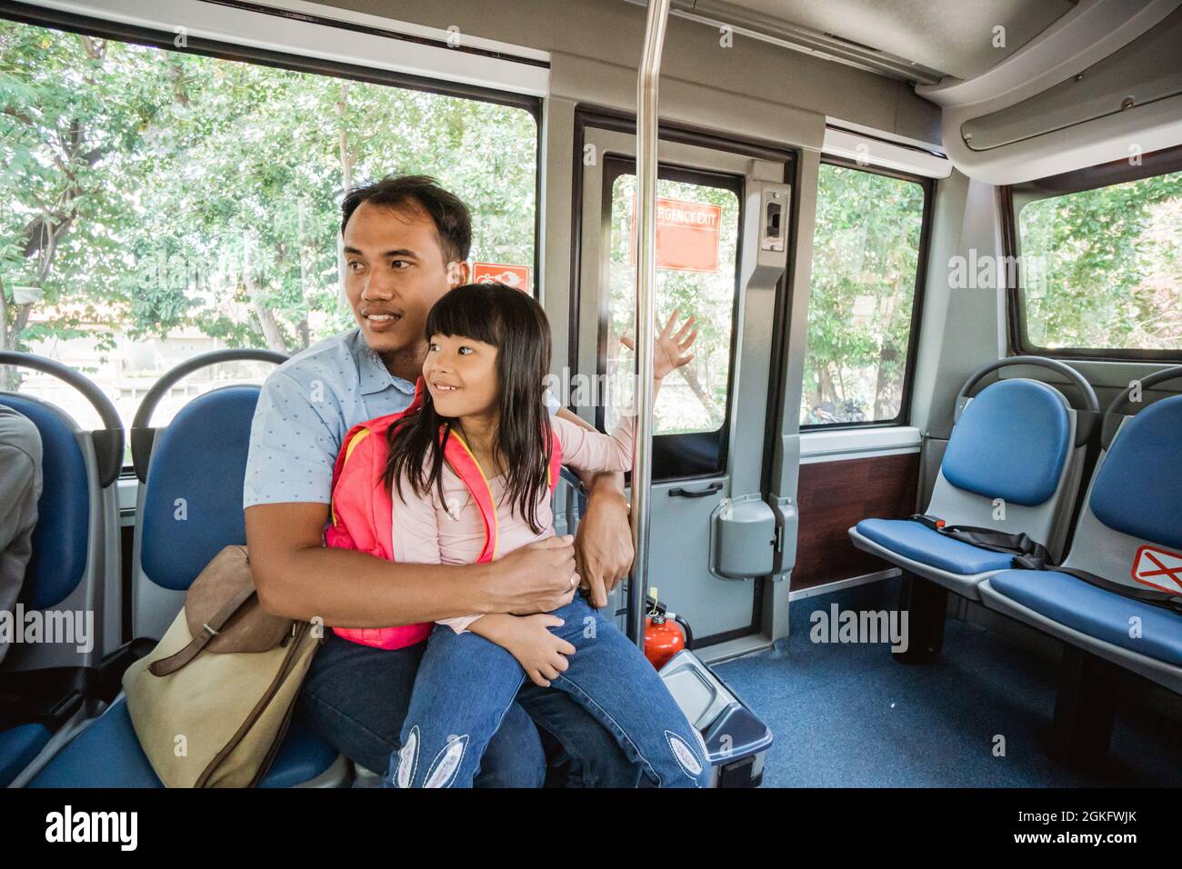 asian father taking his daughter to school by riding bus public ...