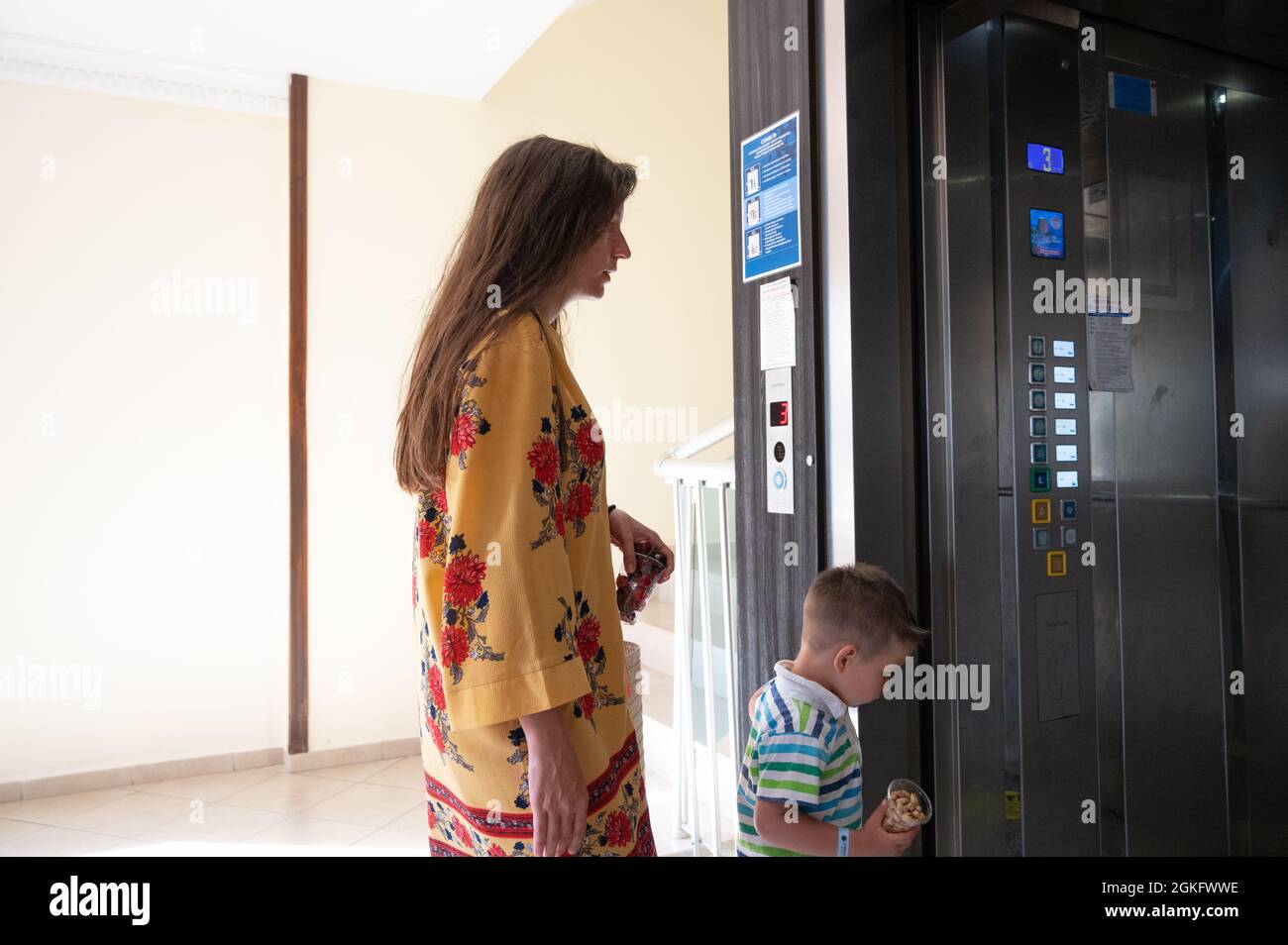 Mom and Child Ride the Elevator Stock Photo - Alamy