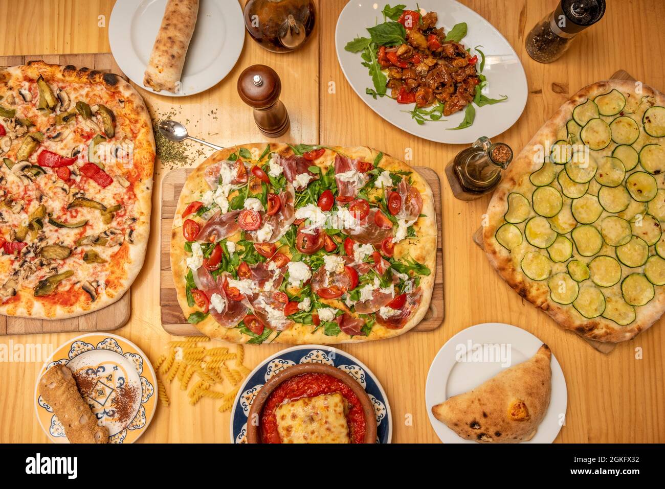 Set of Italian food dishes with olive oil, dehydrated tomato, zucchini ...