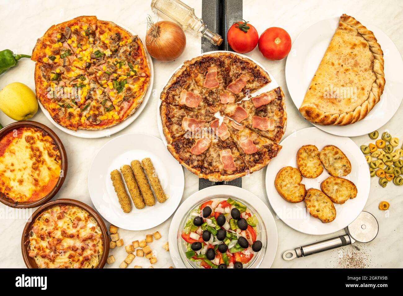 Top view image of Italian food dishes, stuffed calzone, pizza with ...